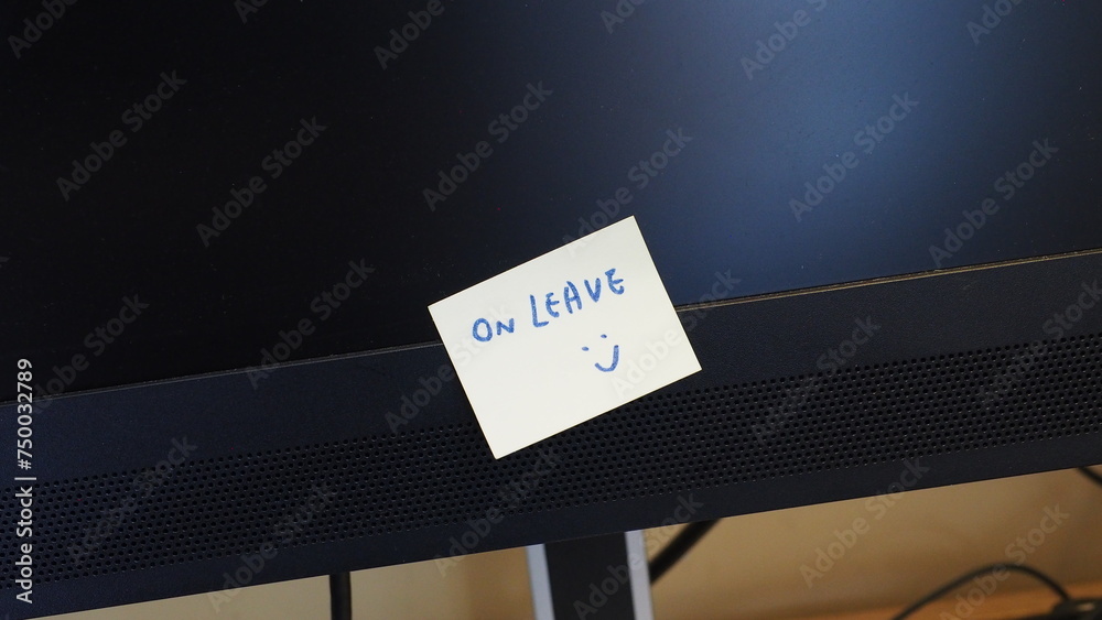 yellow sticky note with handwritten words "On Leave" and a smiley ...