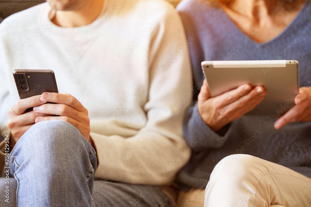Waiting room concept. Mother and son waiting in hospital using tablet ...
