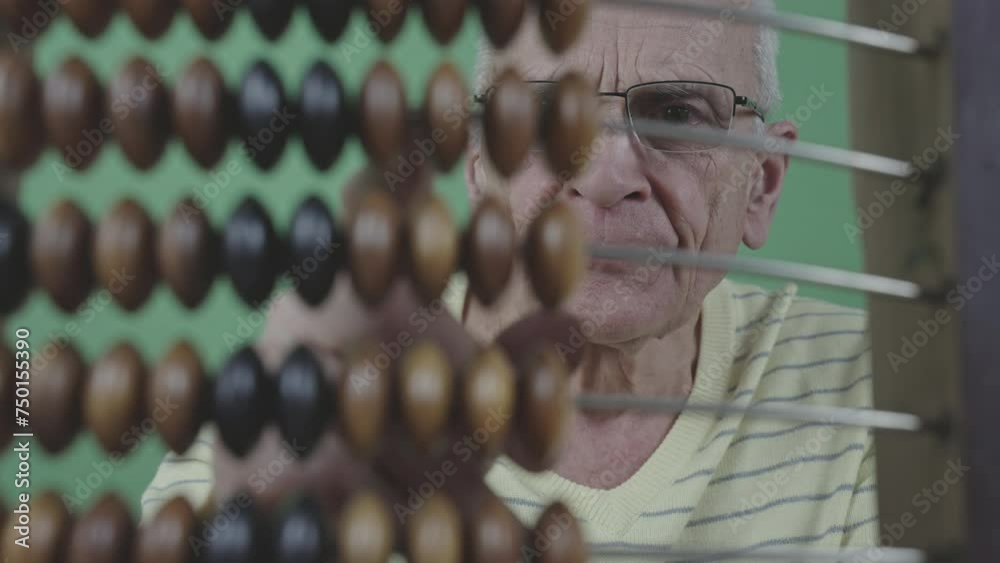 Older man in glasses is calculating with wooden vintage abacus standing ...
