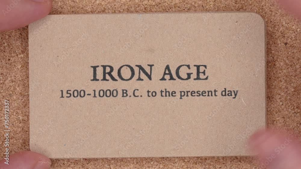 Macro top down shot stack of craft cardboard cards with names of eras ...