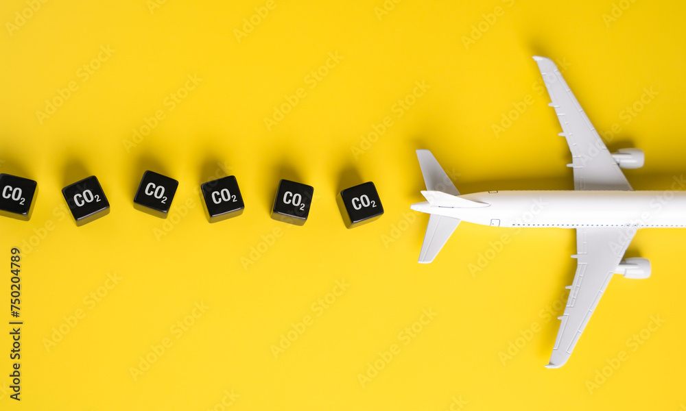 A passenger plane releases CO2 into the atmosphere. Impacting air ...