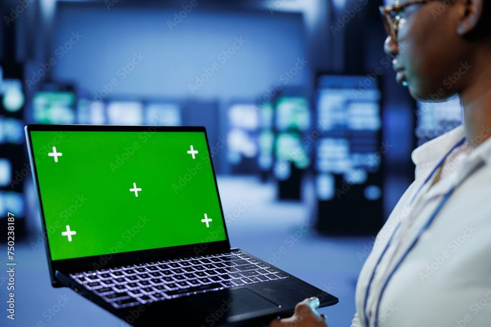 Programmer in server room uses green screen laptop to future proof ... Programmer in server room uses green screen laptop to future proof ...