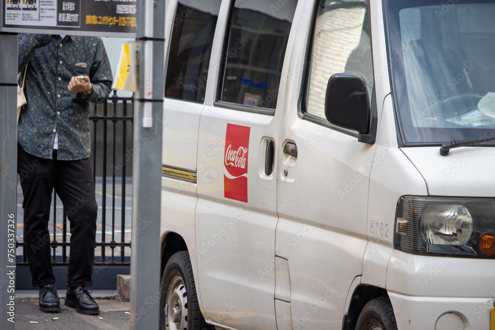 Tokyo, Japan, November 4 2023: Man Walking by a Parked Van with a Coca ...