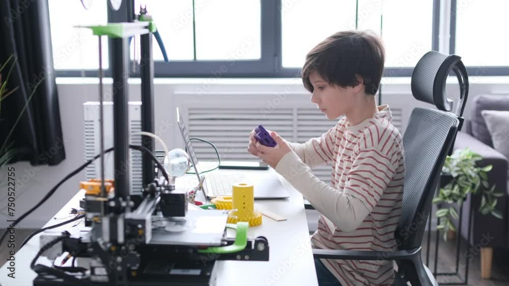 Young Caucasian boy examine 3D printed mechanism detail, learning and ...