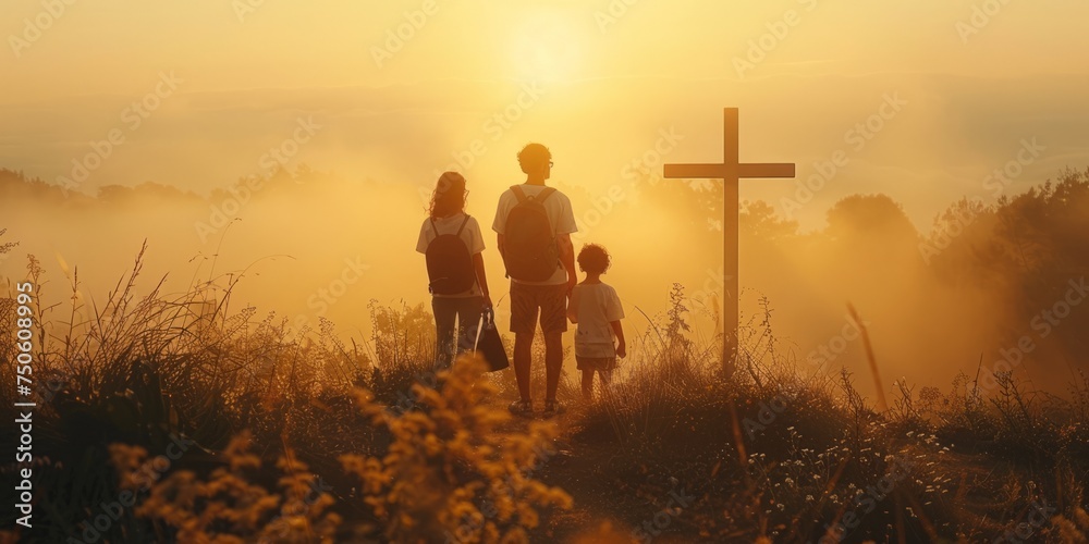 A family stands in front of the cross, a family looks for the silhouette of the cross of Jesus ...