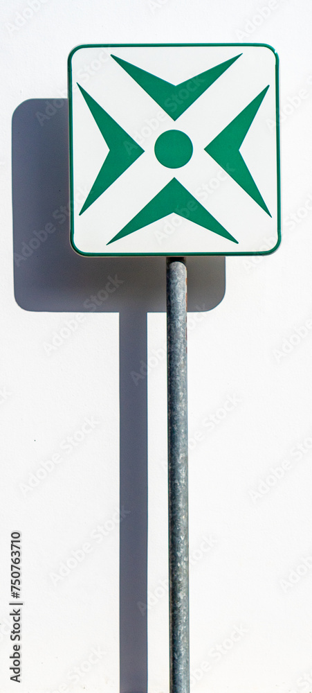 meeting point vertical sign under white wall background with shadow of ...