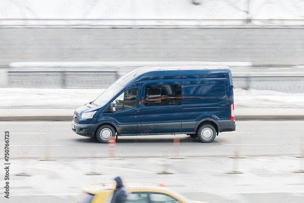 Ford Transit Fourth generation in the city street. Side view of blue ...