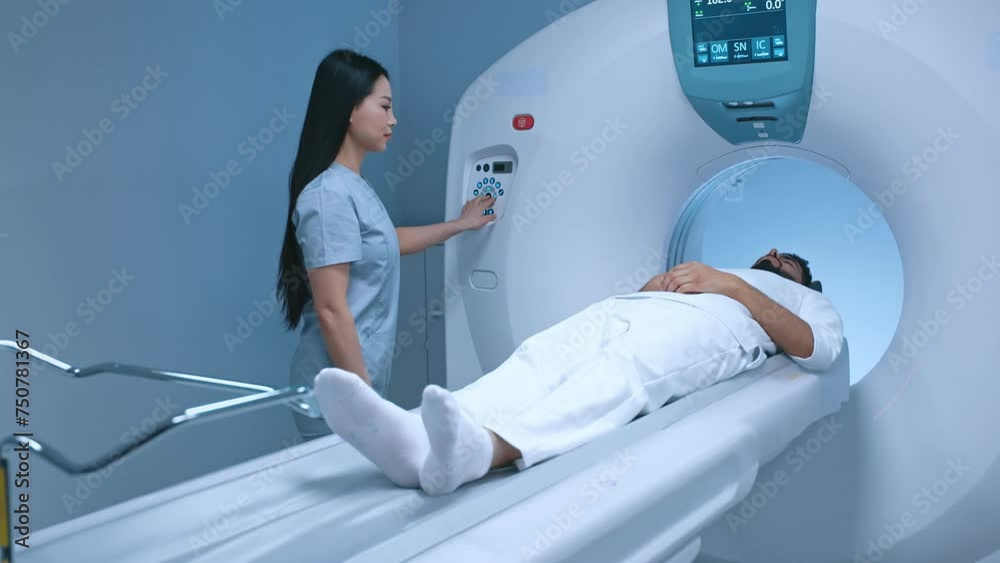 Pretty female doctor performs CT scan for male patient at diagnostic ...
