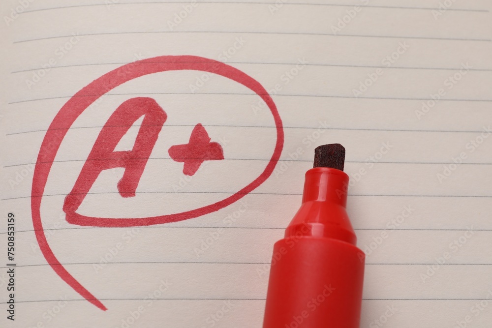 School grade. Red letter A with plus symbol on notebook paper and ...