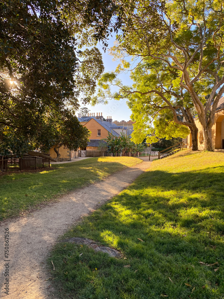 Path in the countryside. Century-old ocre building in the village ...