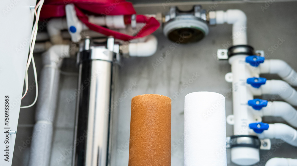 Old and new water filters on filter system background. Plumbing water ...