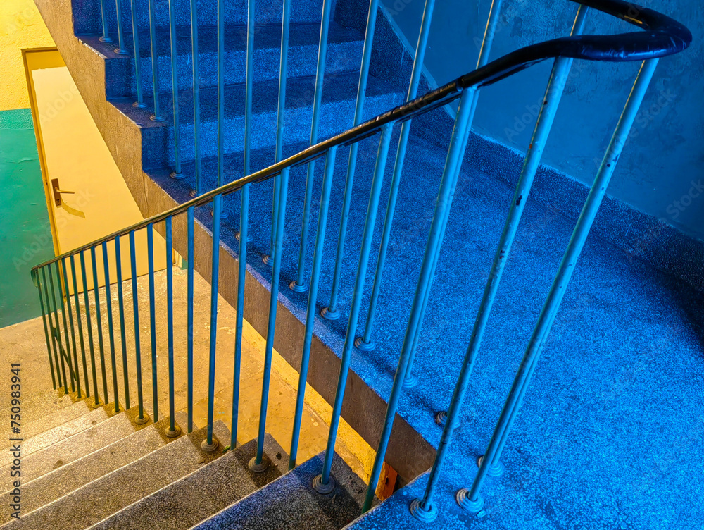 Chill and warmth. Contrasting colors in building interior with stairs ...