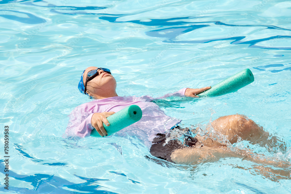 Girl with Down syndrome learns to swim, enjoying the pool on a summer ...