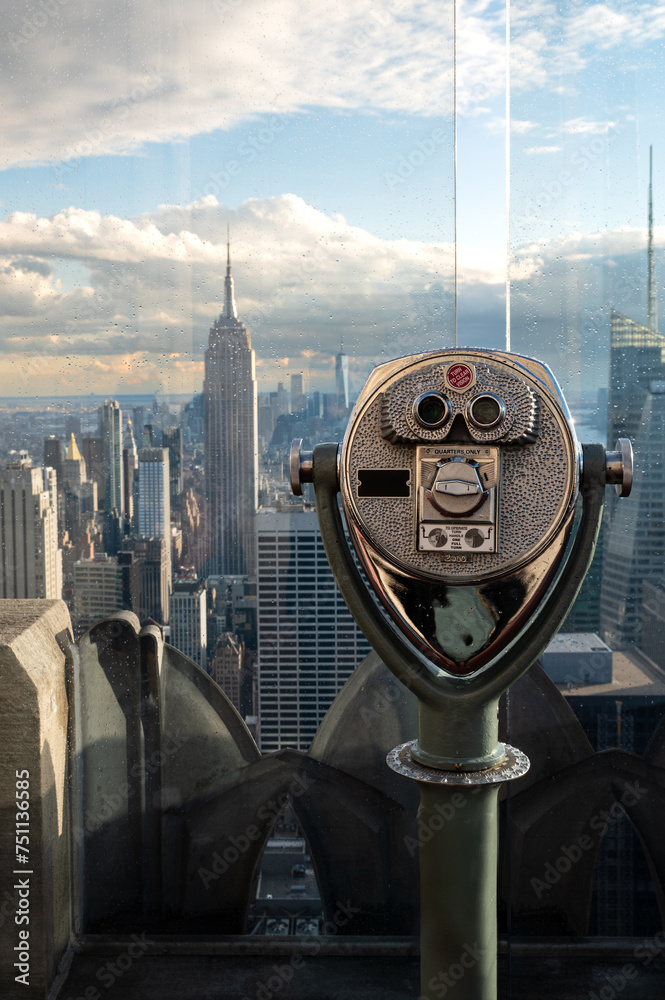 Binoculars on observation platform with empire state building view ...