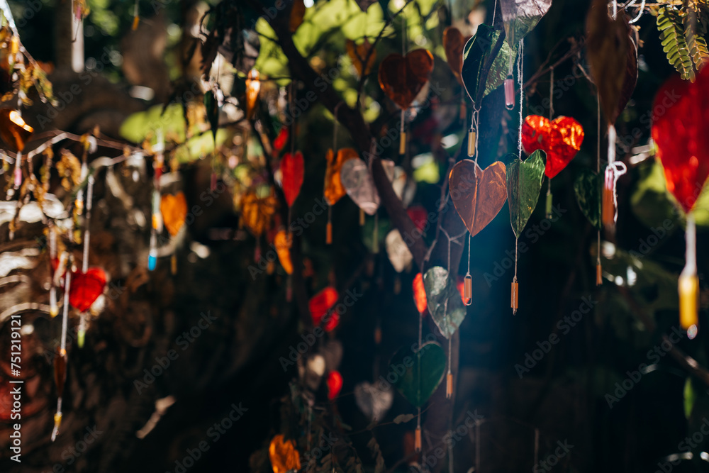 Coloured hearts hanging from a tree in the gardens of a Buddhis temple ...