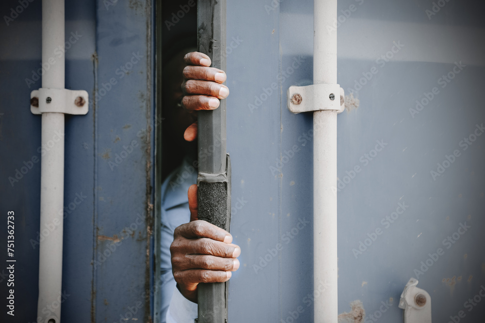 Human trafficking : Hand of a stateless black man hiding container ...