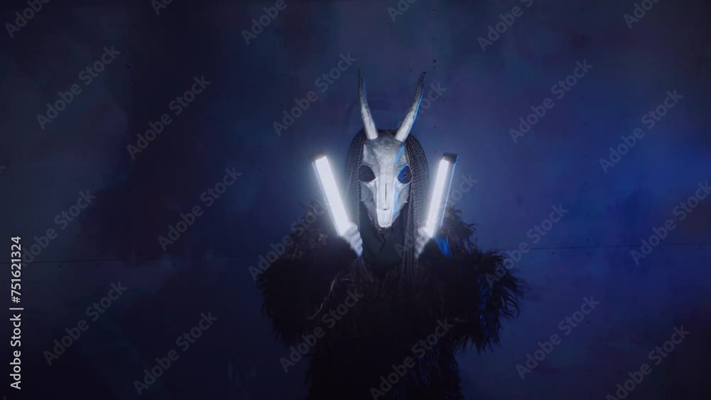 The devil monster dances with RGB sticks in his hands. A mystical man ...
