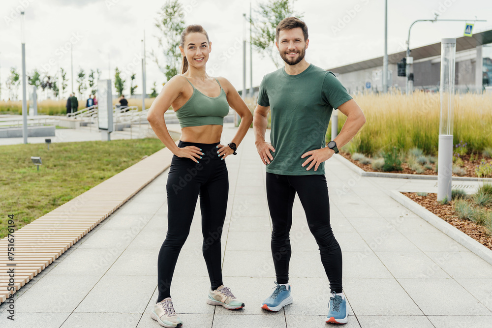 Fit couple posing in workout gear, ready for a fitness session in an ...