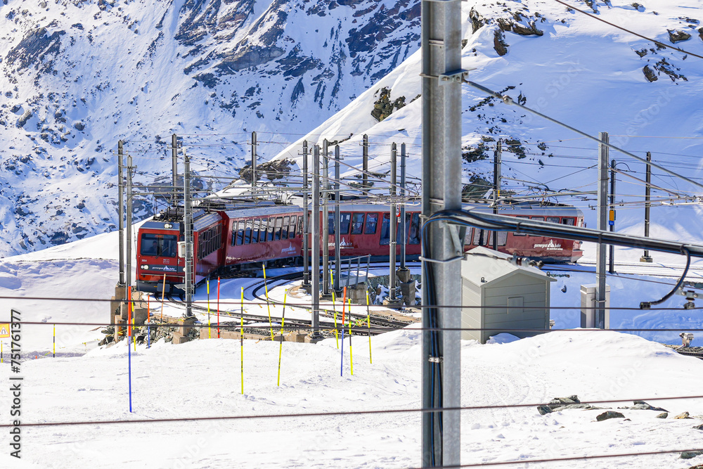 Cogwheel train of the Gornergrat Railway riding on a rack rail above ...