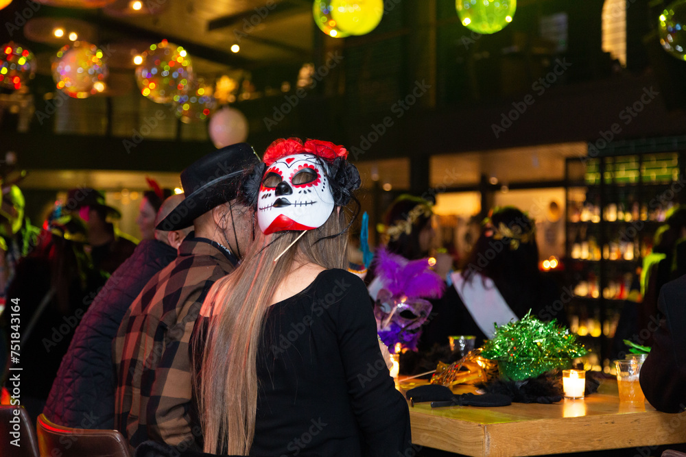 Crowded masquerade party scene with vivid masks, colorful lights, and ...