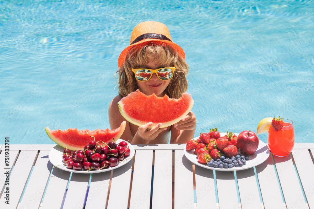 Summer child by the pool eating fruit and drinking lemonade cocktail ...