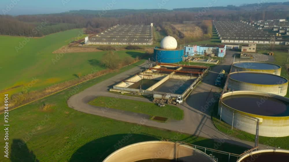 Biogas plant and farm in fields. Renewable energy from biomass. Agriculture prepared for Green ...