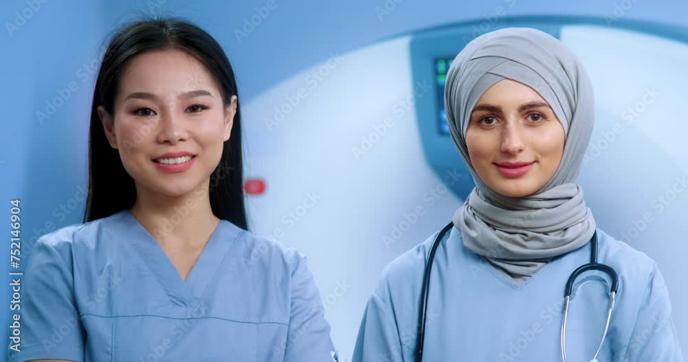 Multicultural medical workers in MRI cabinet. Arabian doctor wearing ...
