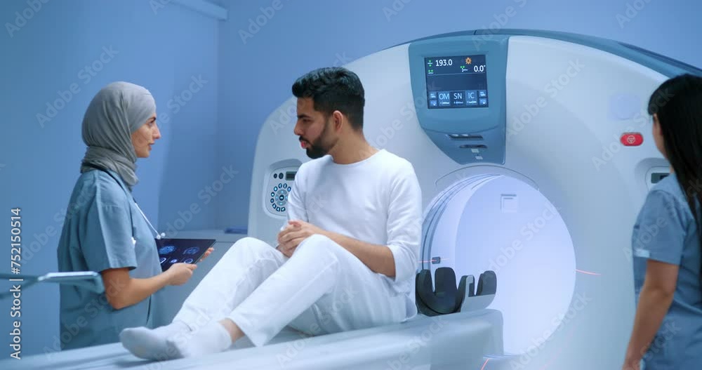 Arabian doctor giving instructions to patient before MRI. Patient ...