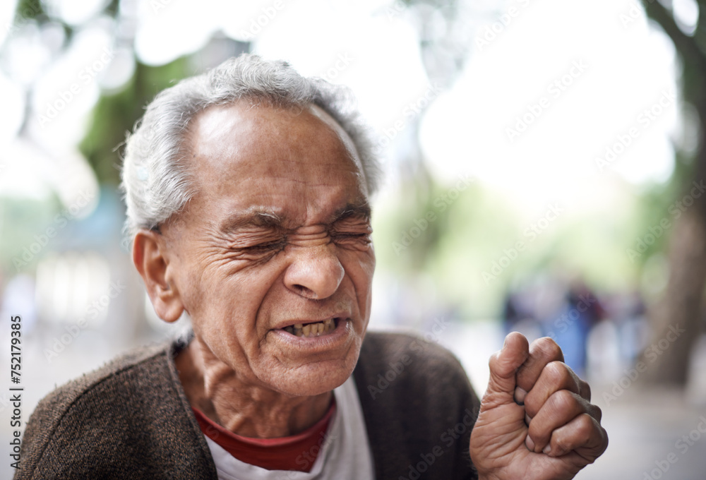 Face, sick and old man sneezing in a street or city in retirement ...