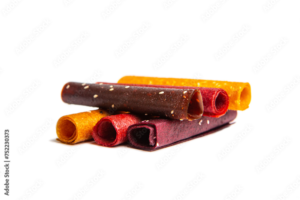 fruit pastilles are rolled into tubes and stacked on top of each other ...