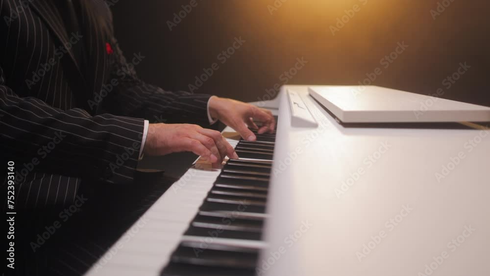 Crop of man sitting on chair and playing musical instrument with soft ...