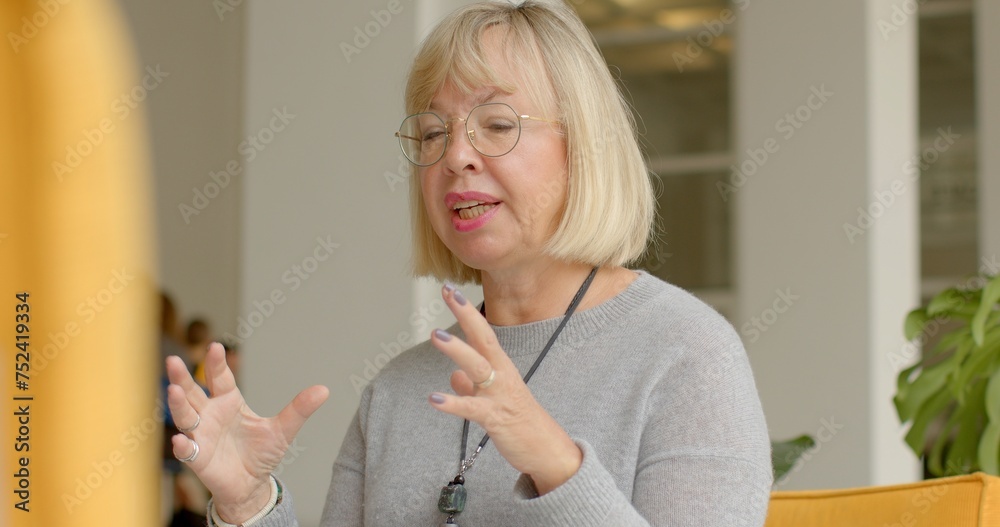 The woman is explaining while bending her fingers, counting. Middle ...