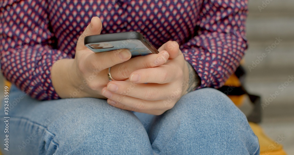Hands are engaged with smartphone during meeting, indicating ...