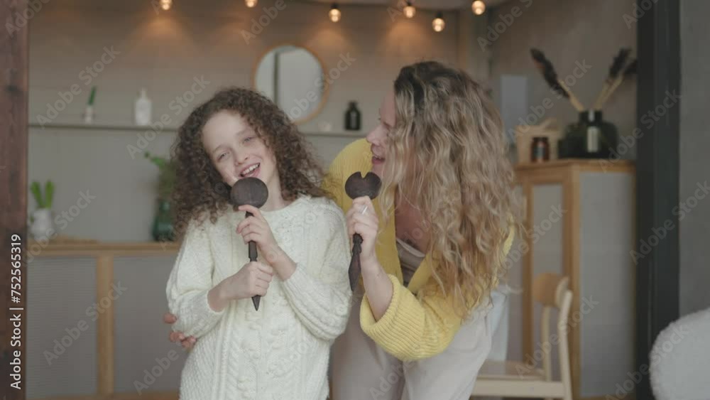 Happy family young mum and cute teenage child daughter hugging singing ...