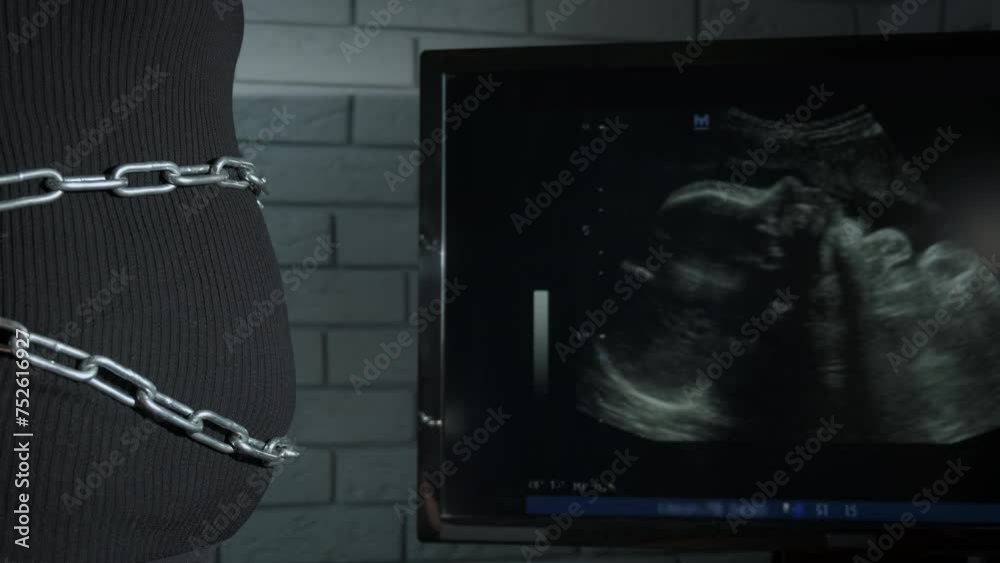 Chained pregnancy belly. A view of woman unchained her pregnant belly ...