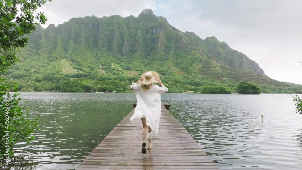 Camera following woman exploring secret beach pond on Hawaii island ...