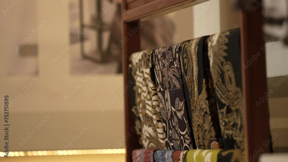 Vidéo Stock Batik cloth hanging on a rack. Clothes rack full of batik ...