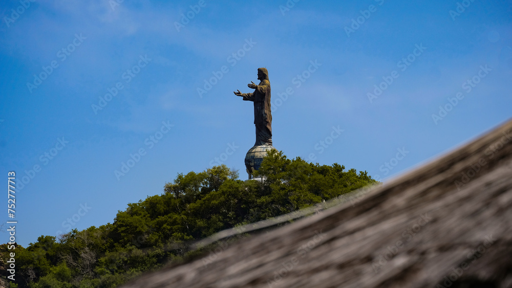 A scenic view of iconic Cristo Rei Jesus statue and a traditional ...