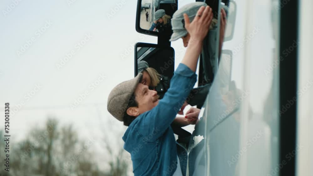 Romantic husband saying goodbye to truck driver wife before she goes on ...