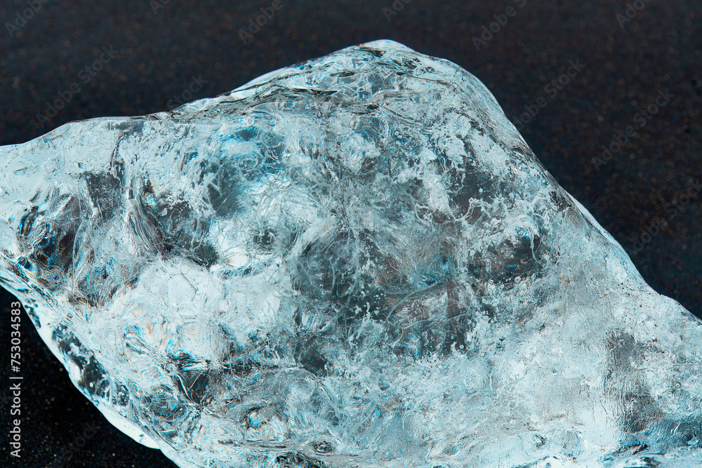 Close-up of a clear, textured ice chunk that looks like a diamond on a ...