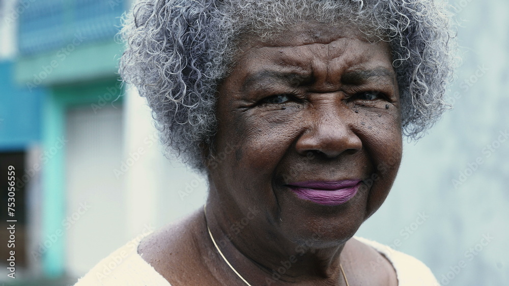 One pensive senior black lady with wrinkled face and gray hair ...