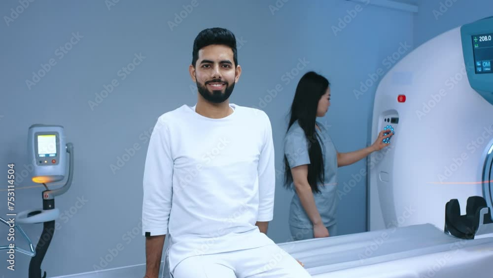 Indian patient undergoing magnetic resonance tomography. Cheerful patient getting ready for ...