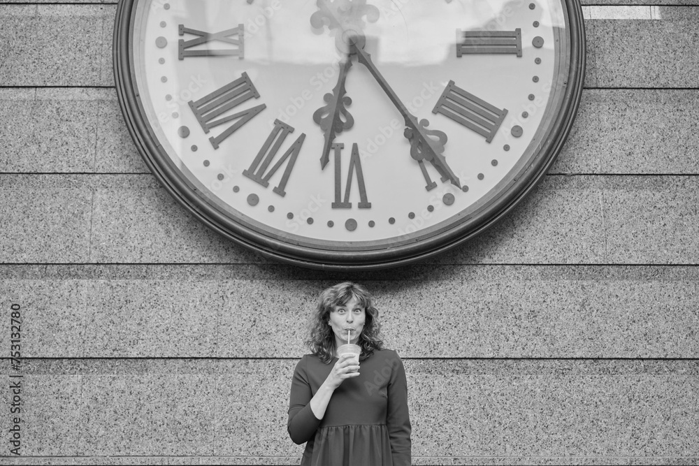 Watch the time concept. woman in dark red dress with cold tea next to ...