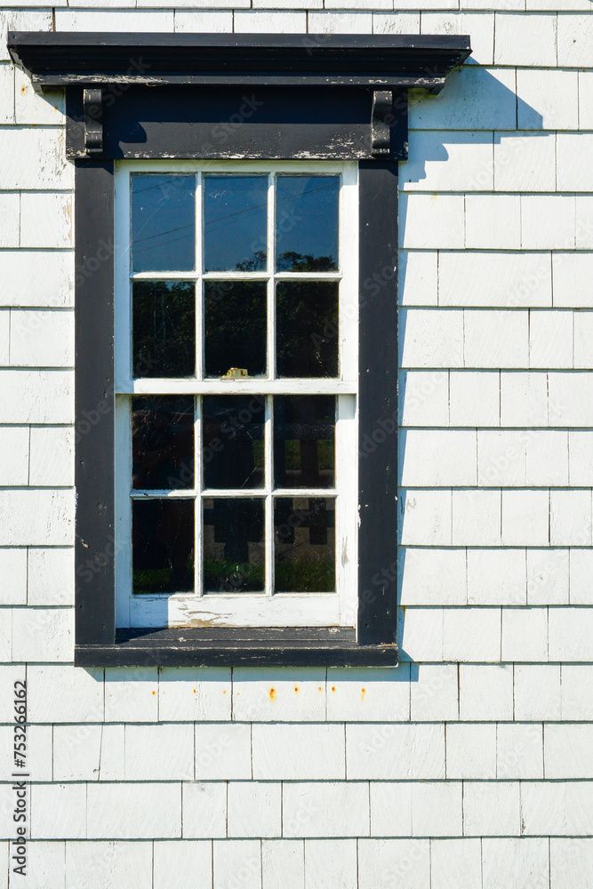 The exterior wall of a white cedar shake wooden clapboard covered the ...