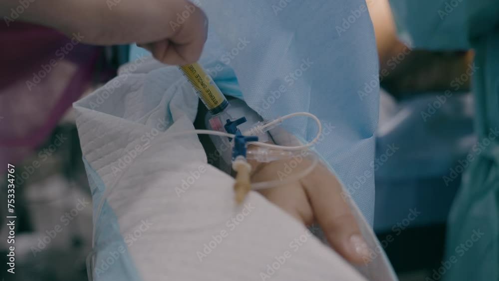 Close up hands doctor nurse inject iv anesthesia in catheter ...