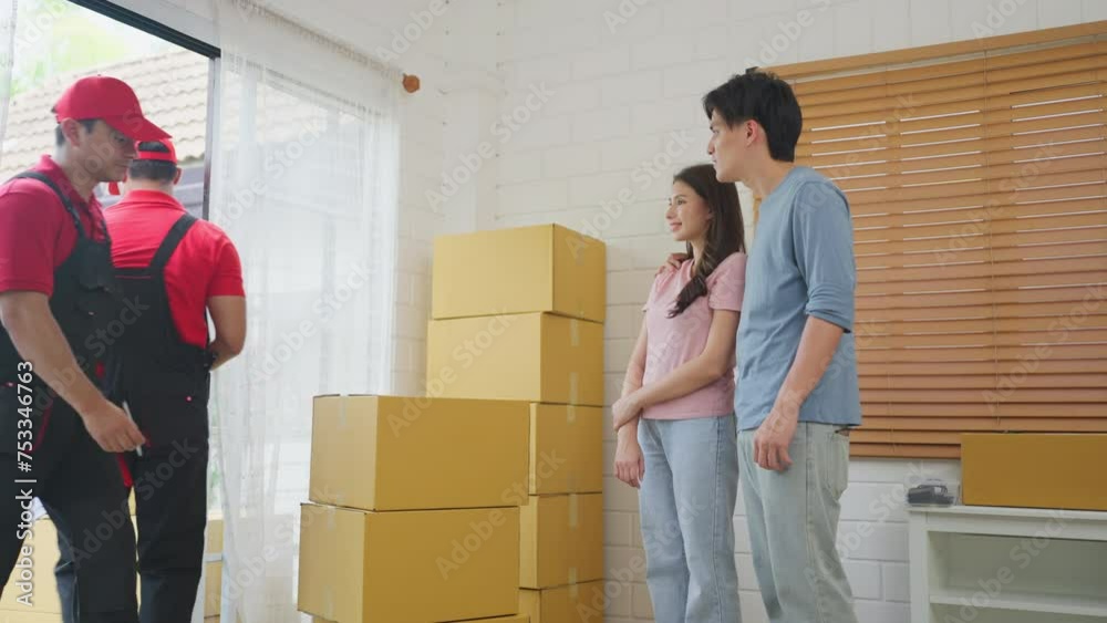 Vidéo Stock Asian man and woman stand in front area of their house to ...