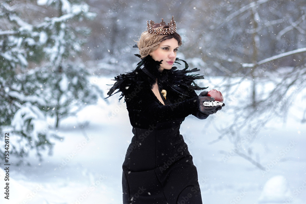 A beautiful young lady in a long black dress, with a crown on her head ...