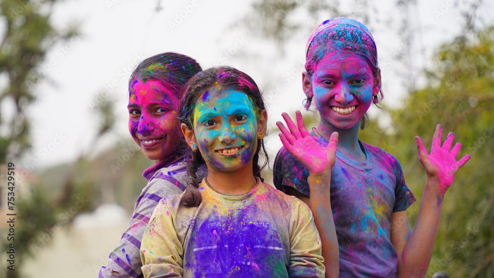 Indian kids playing with colours or asian children celebrating holi ...