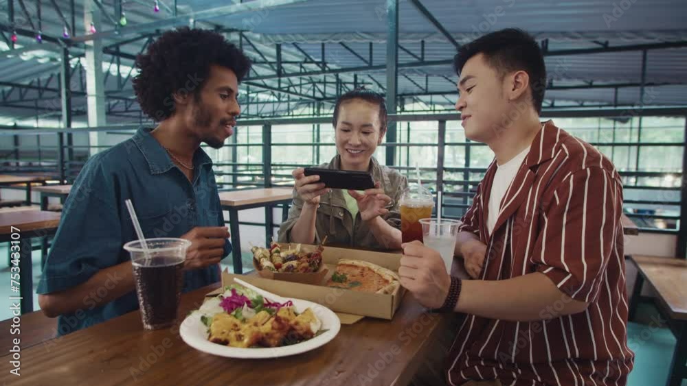 Medium shot of young woman taking photo of ordered street food for her ...
