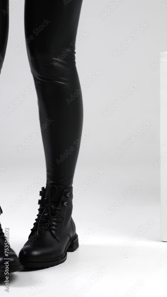 Female legs wearing black leather pants and boots. Stylish footwear ...